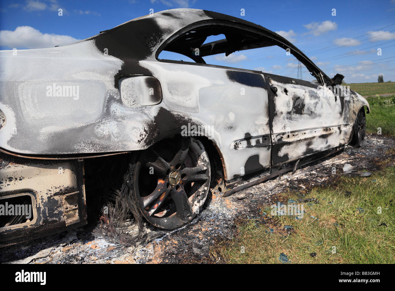 A burnt out shell of a Mercedes Benz Coupe left in rural farmland Stock ...