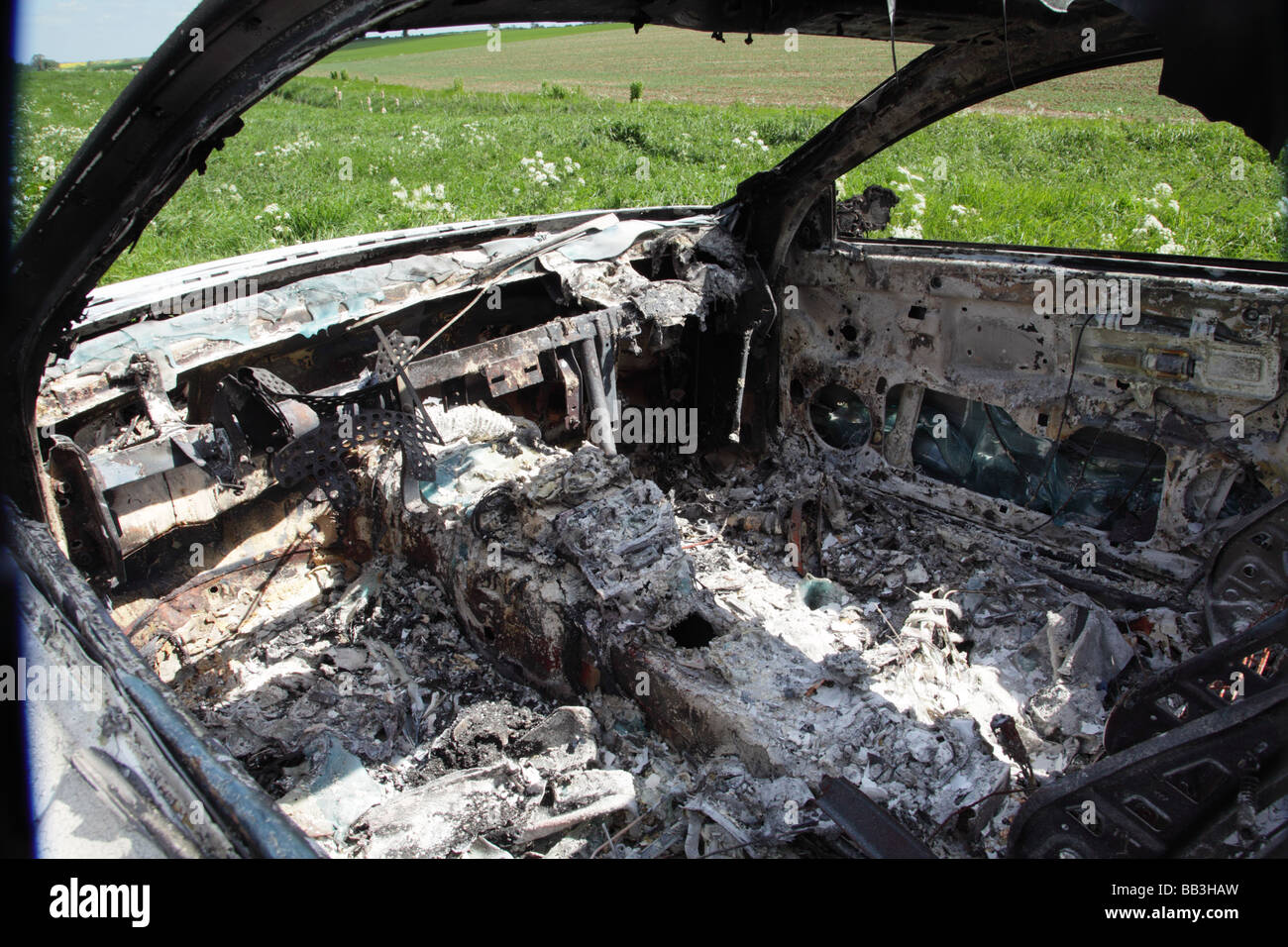 A burnt out shell of a Mercedes Benz Coupe left in rural farmland Stock ...