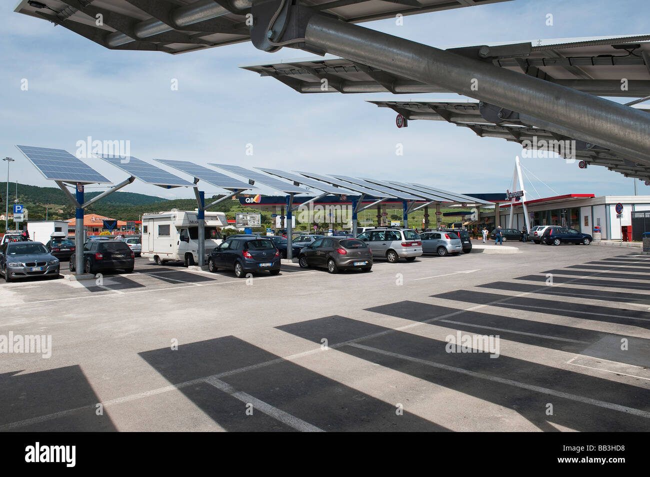 Solar panels used to simultaneously shade parked cars and to generate ...