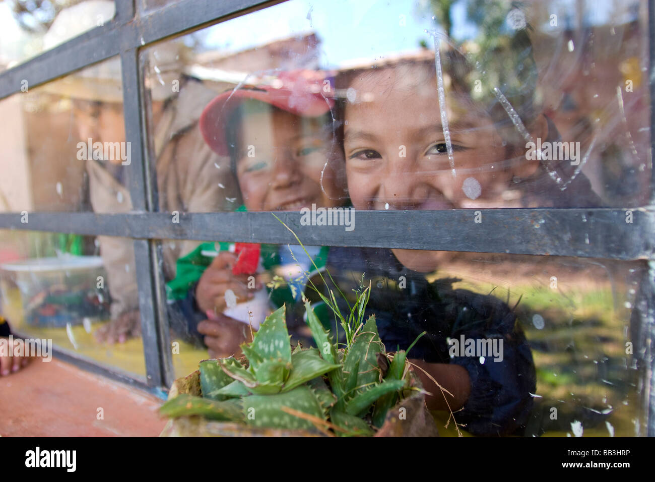Children looking through window in Los Jardines, Peru Stock Photo - Alamy