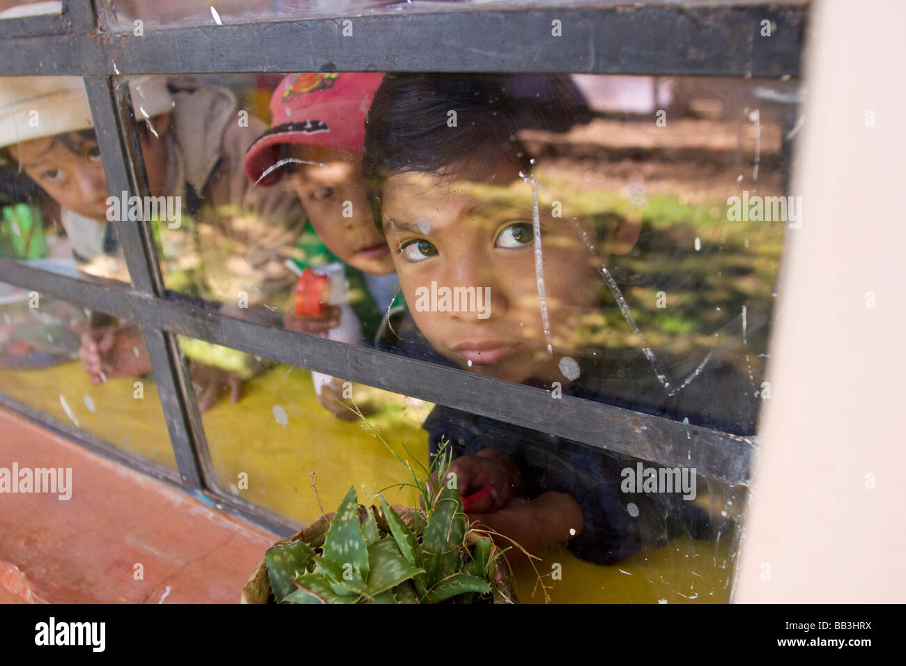 Children looking through window in Los Jardines, Peru Stock Photo - Alamy