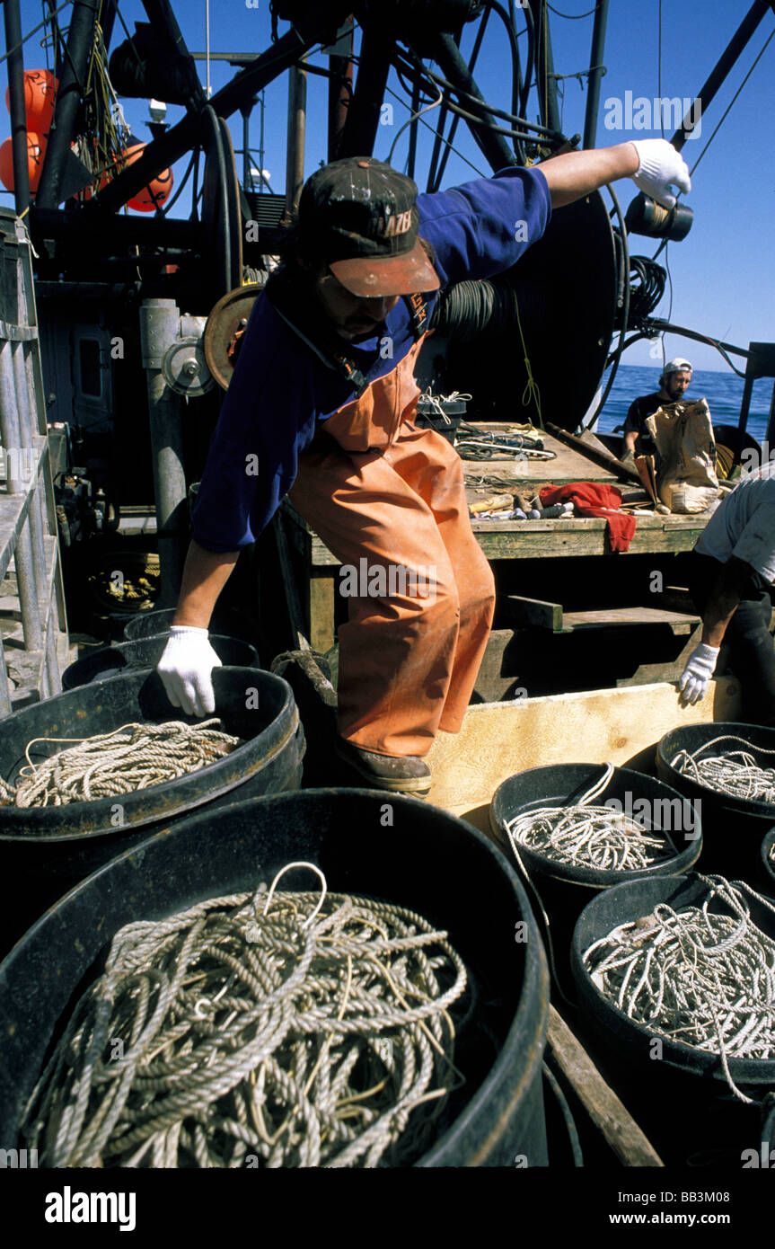 North America, USA, Alaska, Kodiak Island. Fisherman tossing line hooks ...