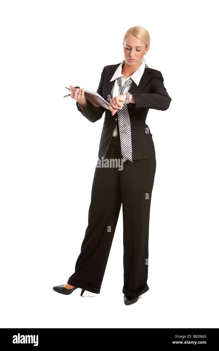 Business woman checking the time on her watch while standing Stock ...