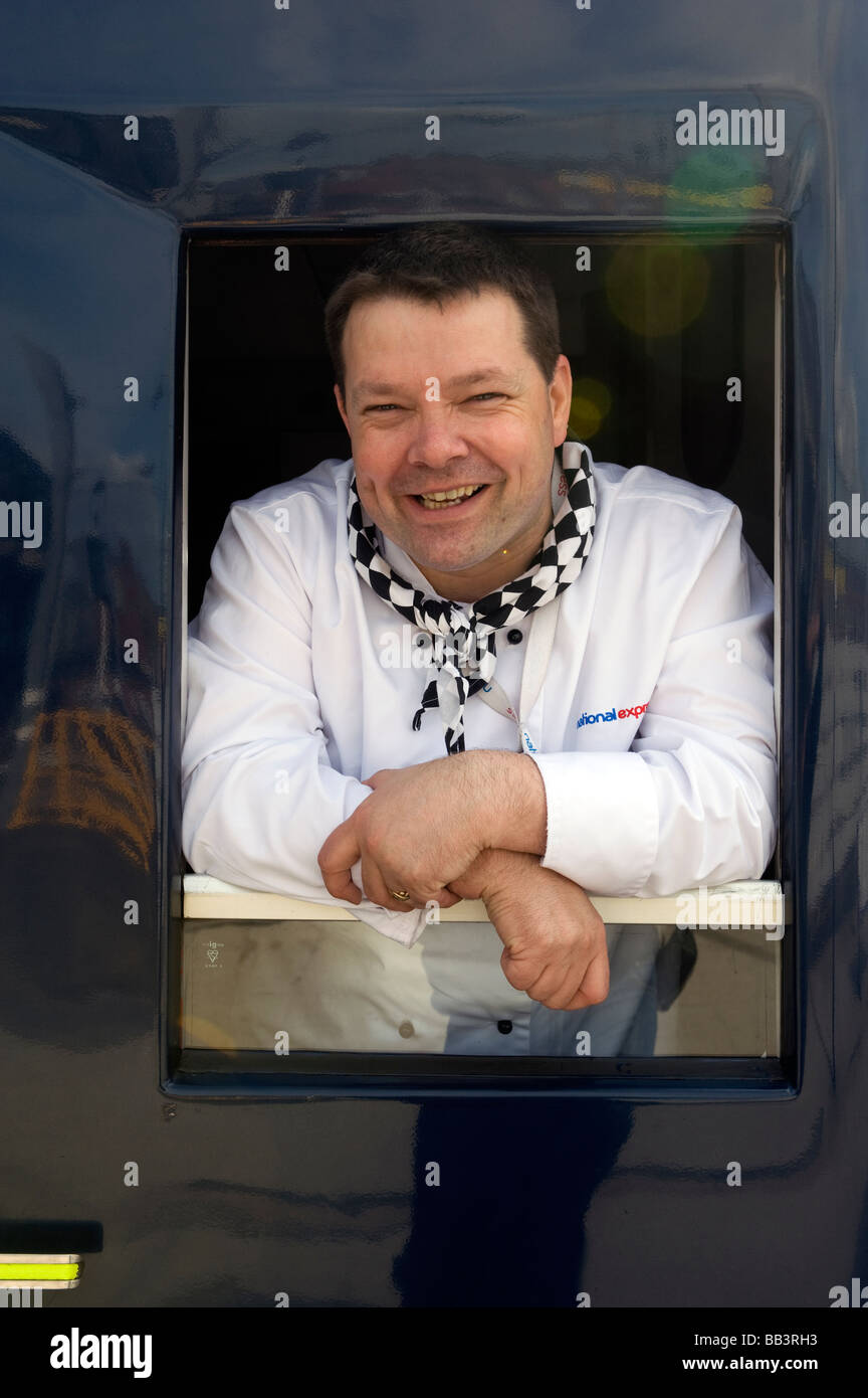 Chef on main line intercity train looking through the coach window at ...