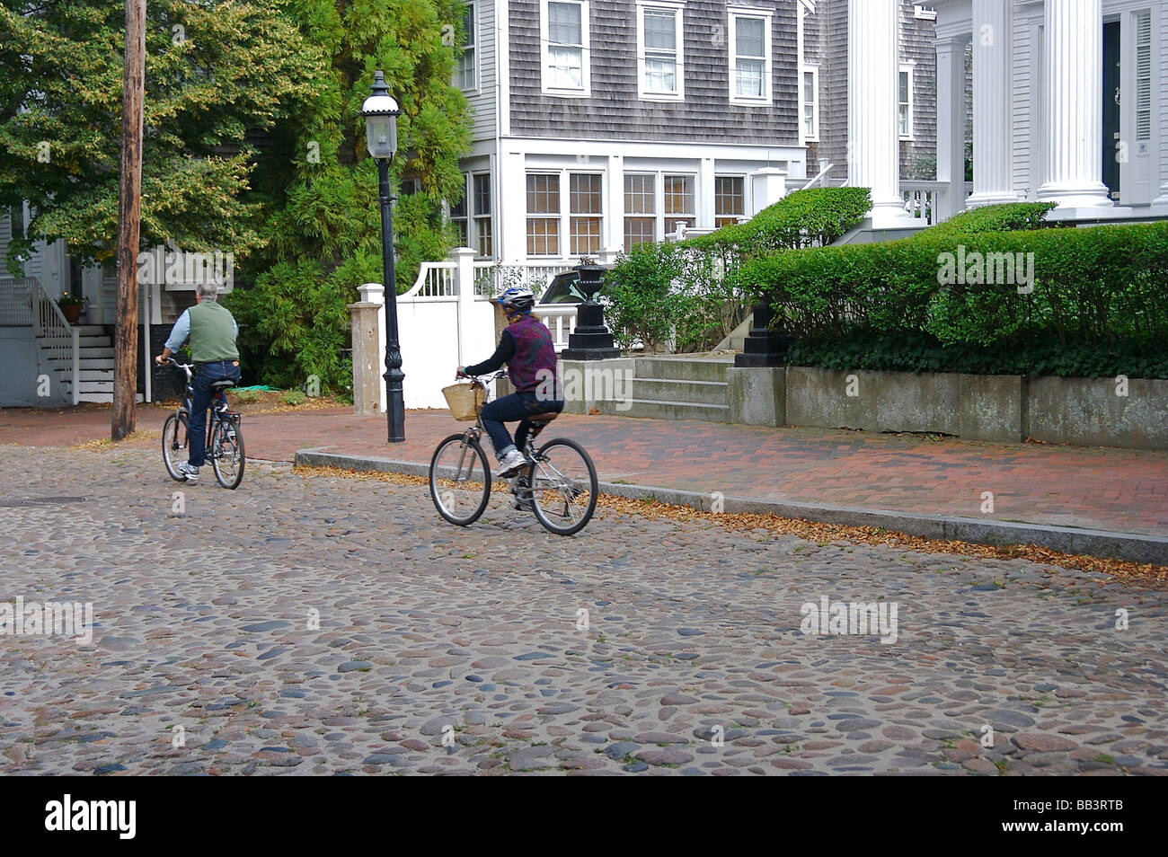 North America, USA, Massachusetts, Nantucket. Bicyclists ride over ...