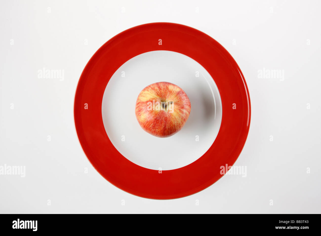 Apple on plate, elevated view Stock Photo - Alamy