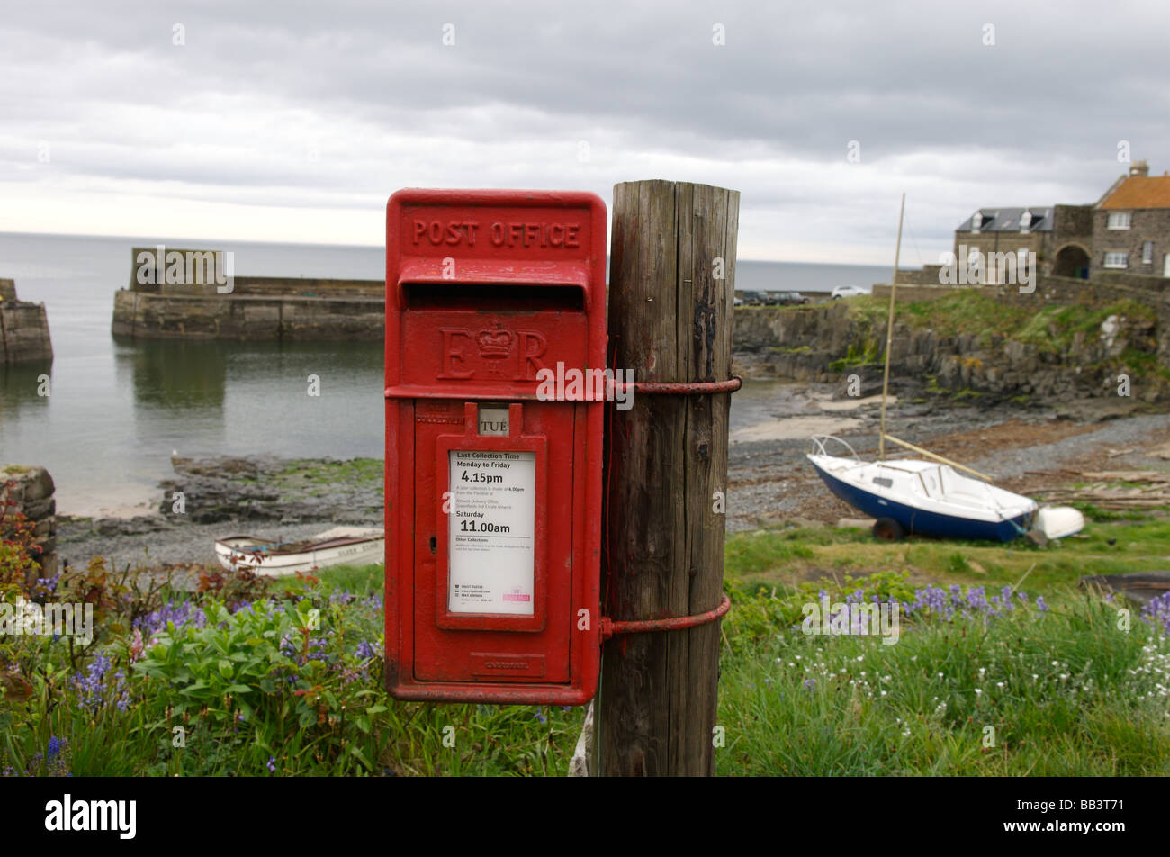 A red post box in Craster harbour, Northumberland Stock Photo - Alamy