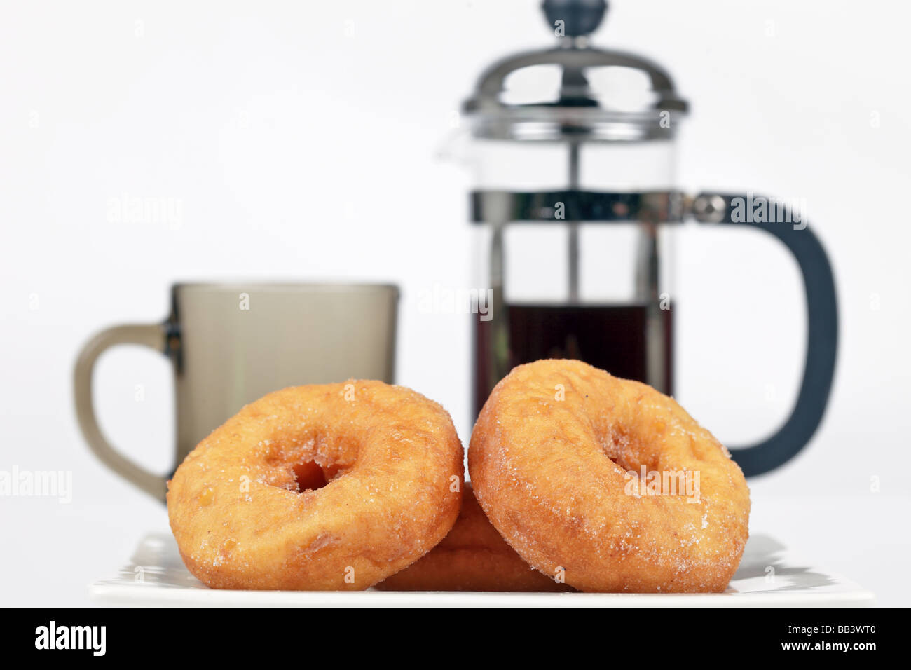 Doughnuts and coffee with coffee pot and cup as background Stock Photo ...