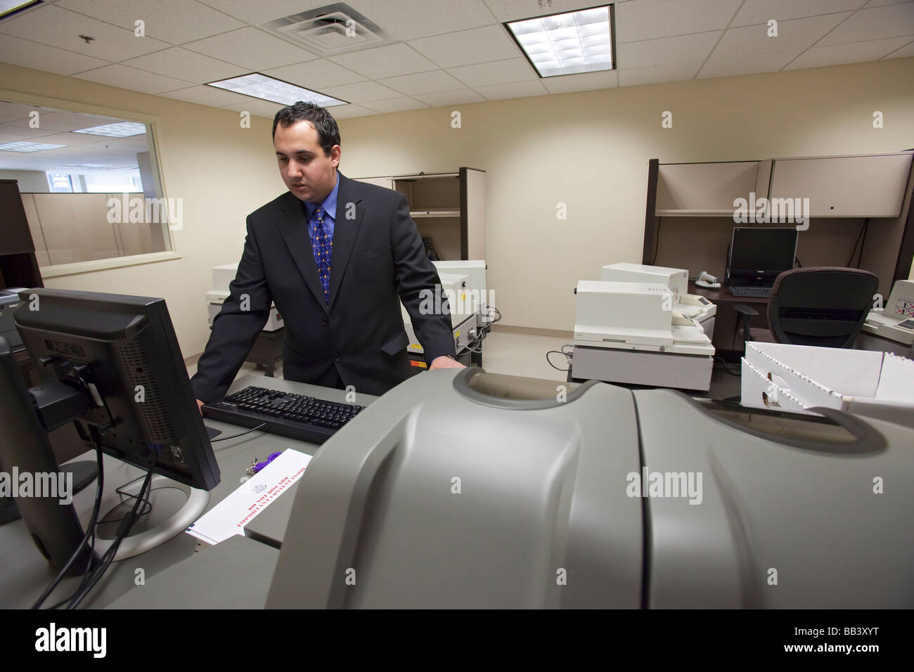 Detroit Michigan A worker operates a machine that makes passport cards ...