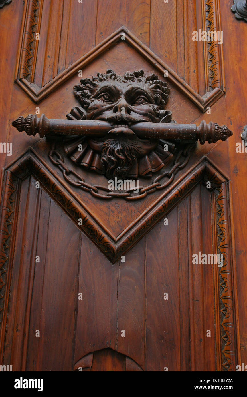 Menacing wooden sculpted lion heads on the doors of a Spanish colonial ...