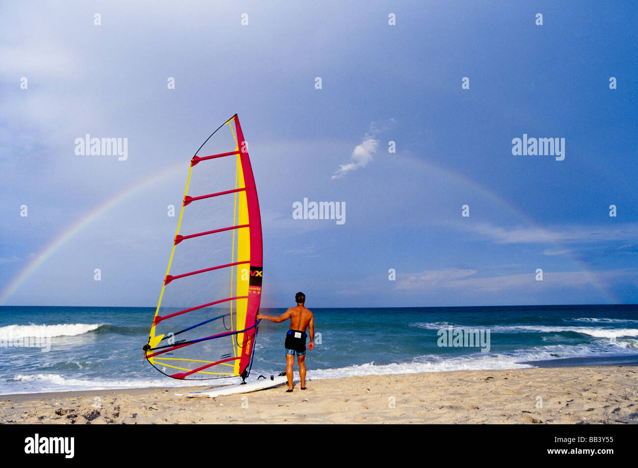 Windsurfer at oceans edge, with rainbow over ocean, Florida Stock Photo ...
