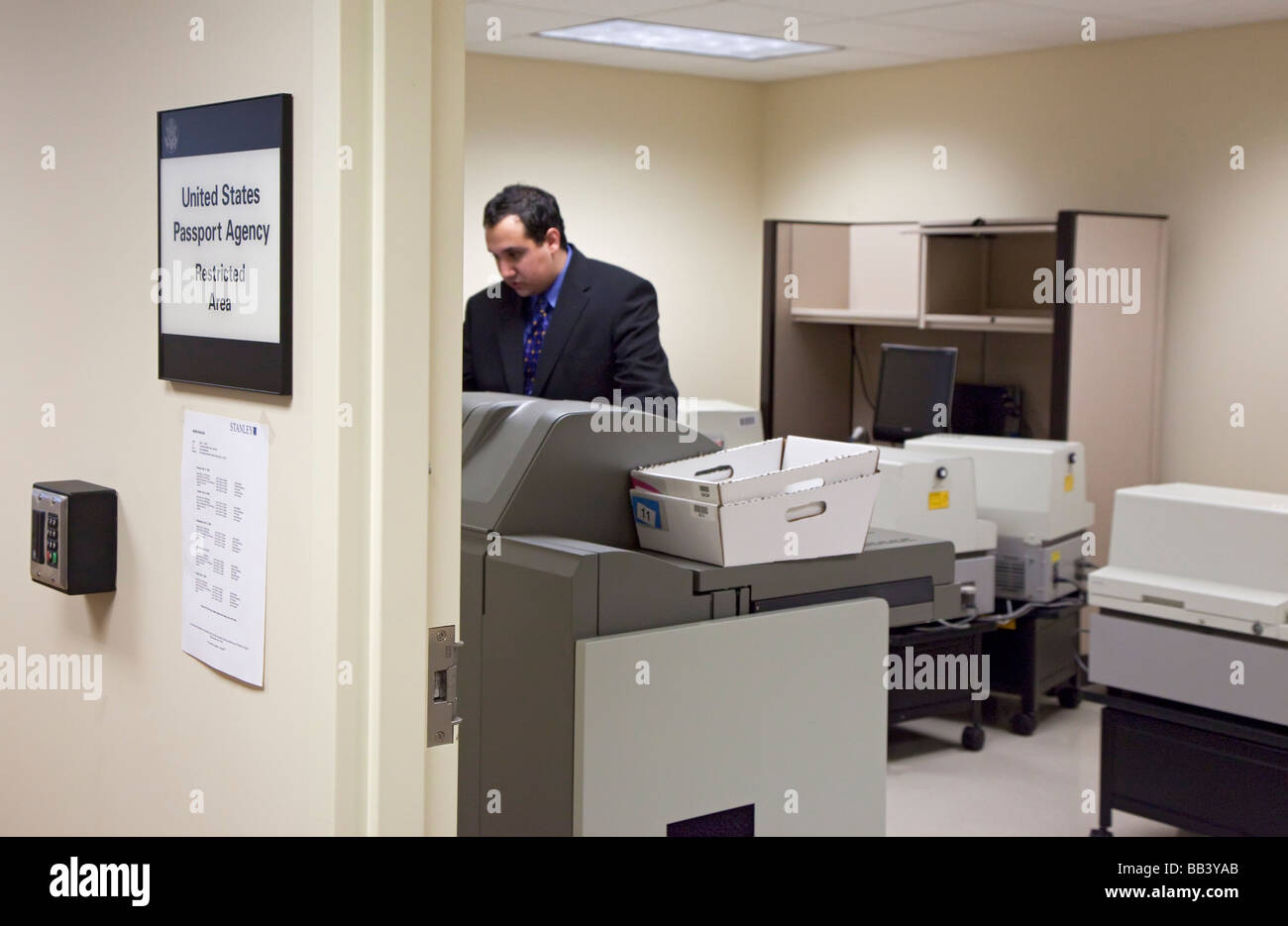 Detroit Michigan A worker operates a machine that makes passport cards ...