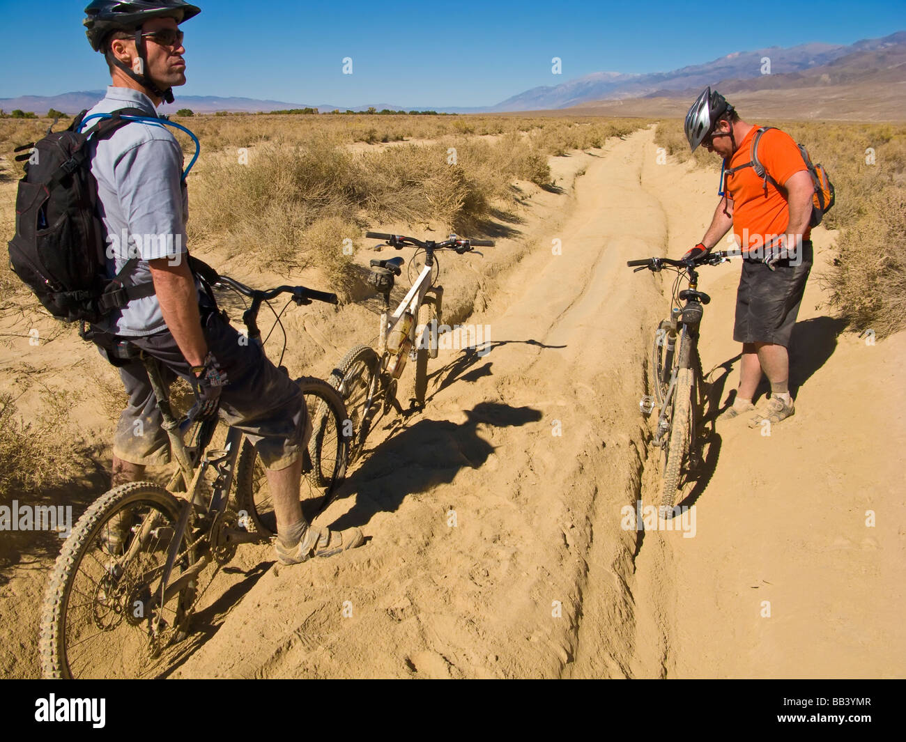 Mountain bikers bogged down in deep loose sand Stock Photo - Alamy