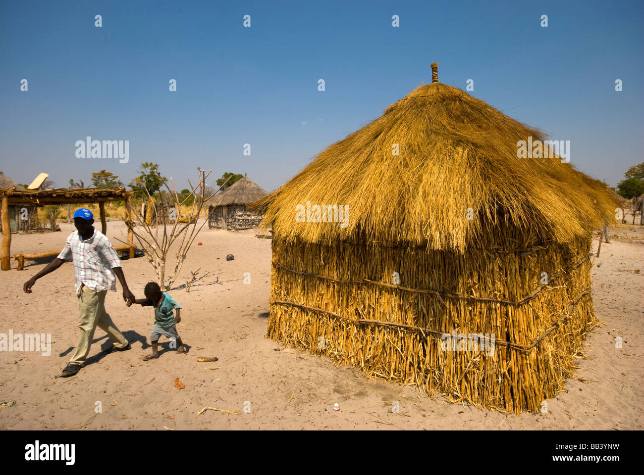 Men from Angola and his son near his small hut in the Caprivi Strip ...