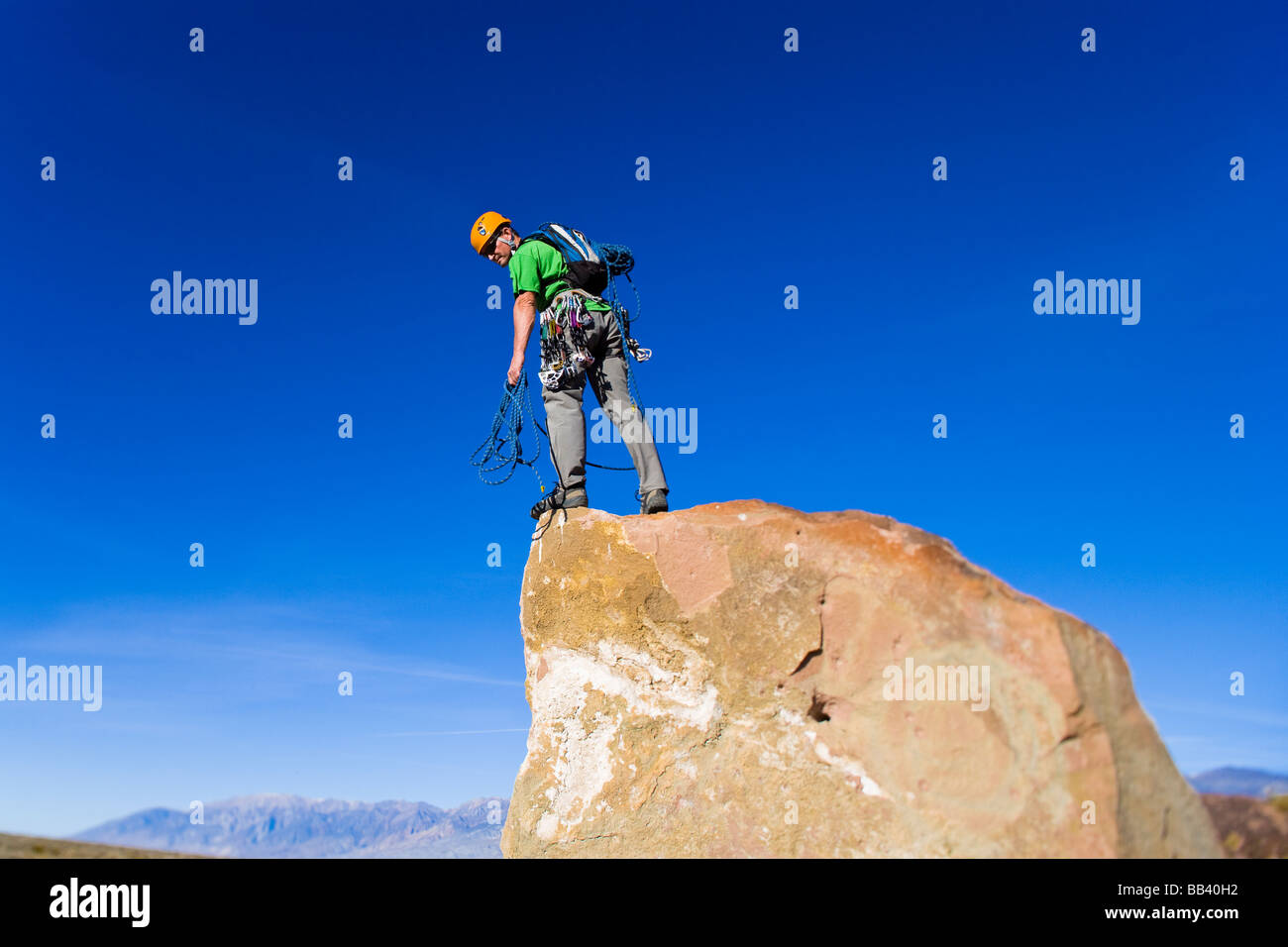Climber on the summit of a rock spire Stock Photo - Alamy
