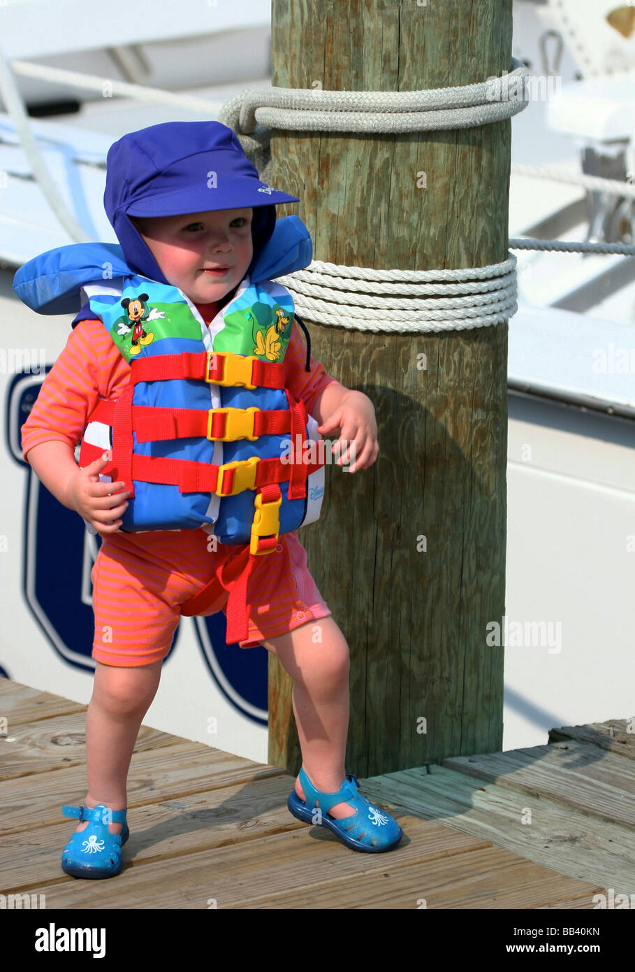 Toddler on Dock - blue sun hat, colorful life jacket Oregon Inlet, NC ...
