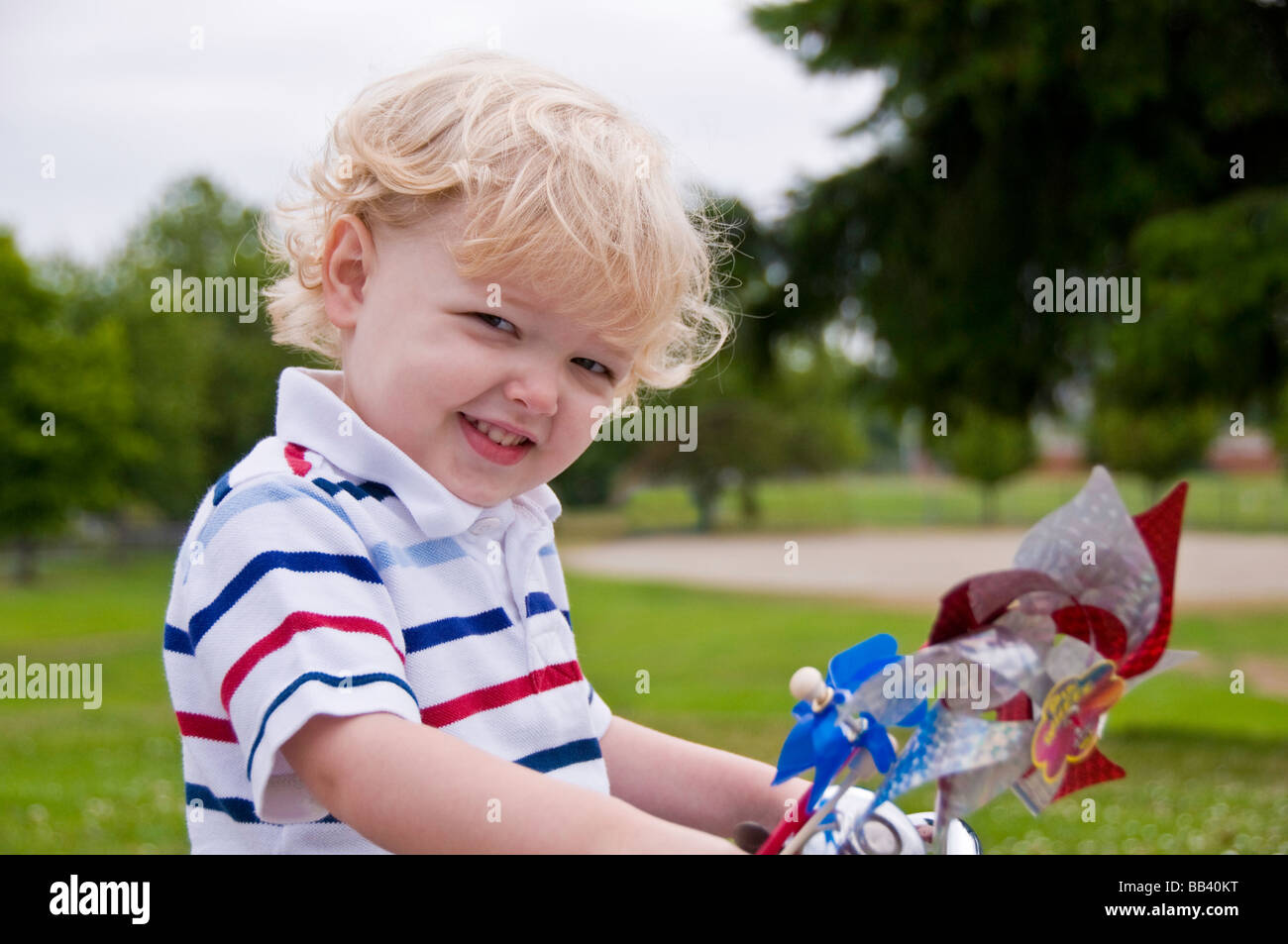 Young boy with pinwheels Stock Photo - Alamy