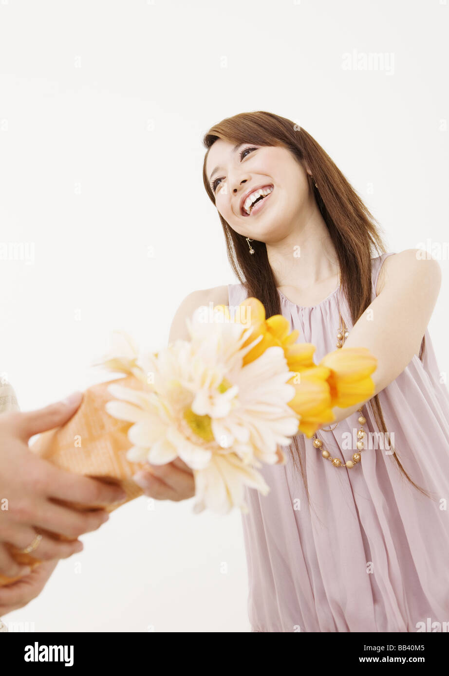 Woman receiving bouquet Stock Photo - Alamy