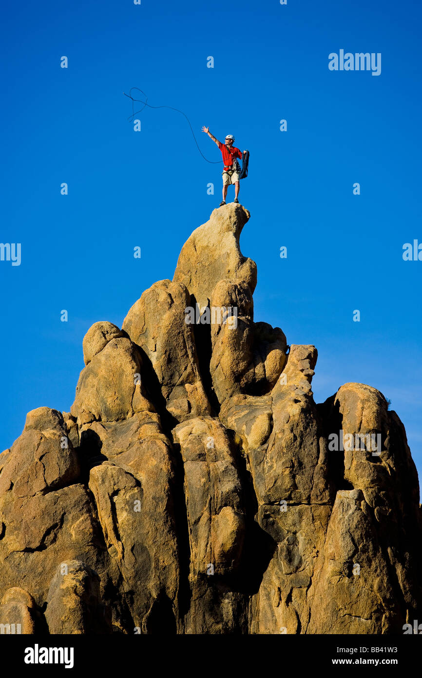 Climber on the summit of a rock spire Stock Photo - Alamy