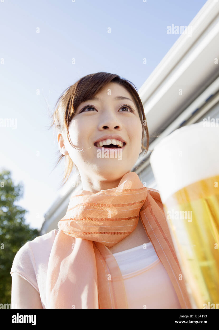 Woman holding beer mug Stock Photo - Alamy