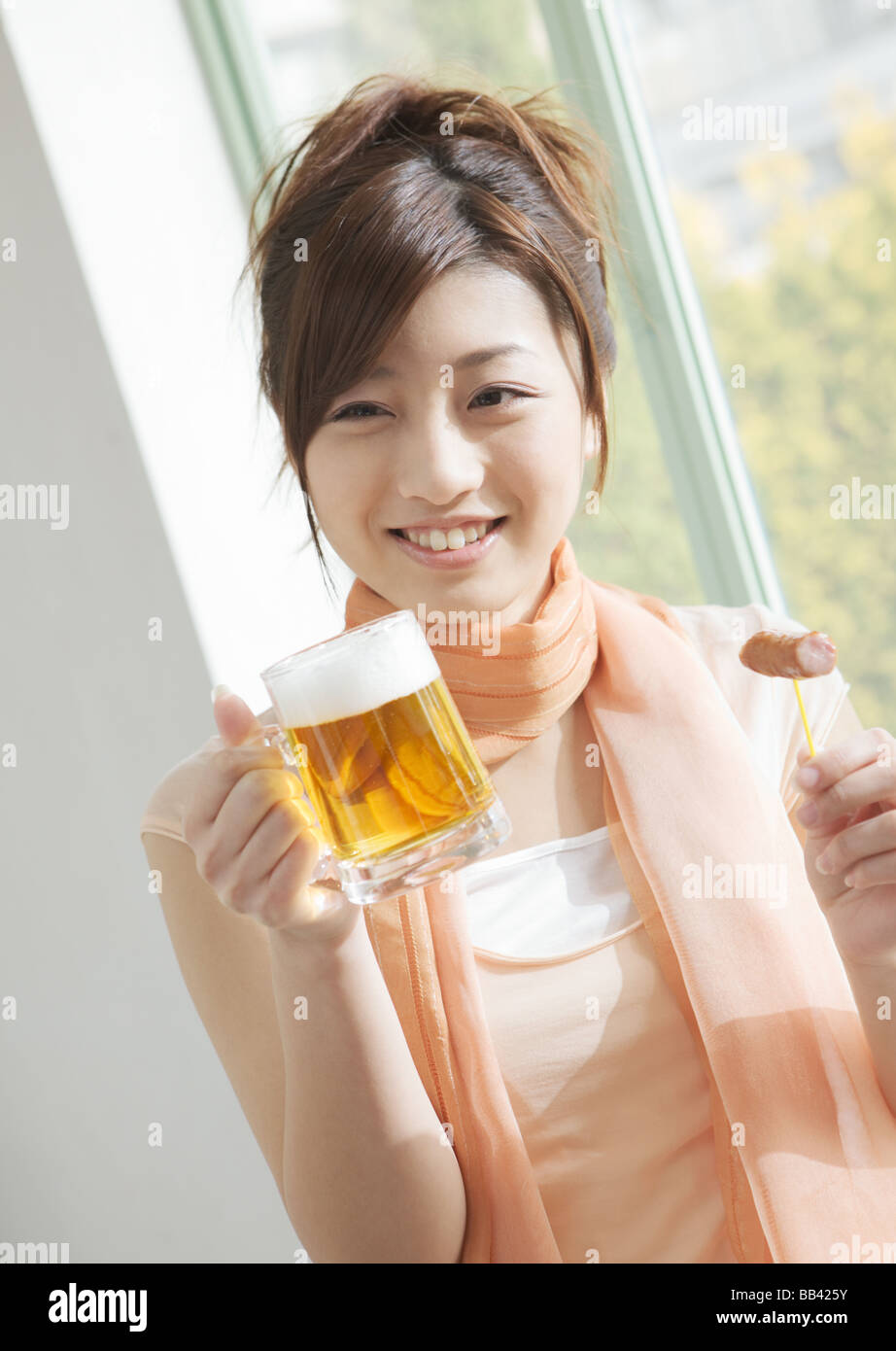 Woman holding beer mug Stock Photo - Alamy
