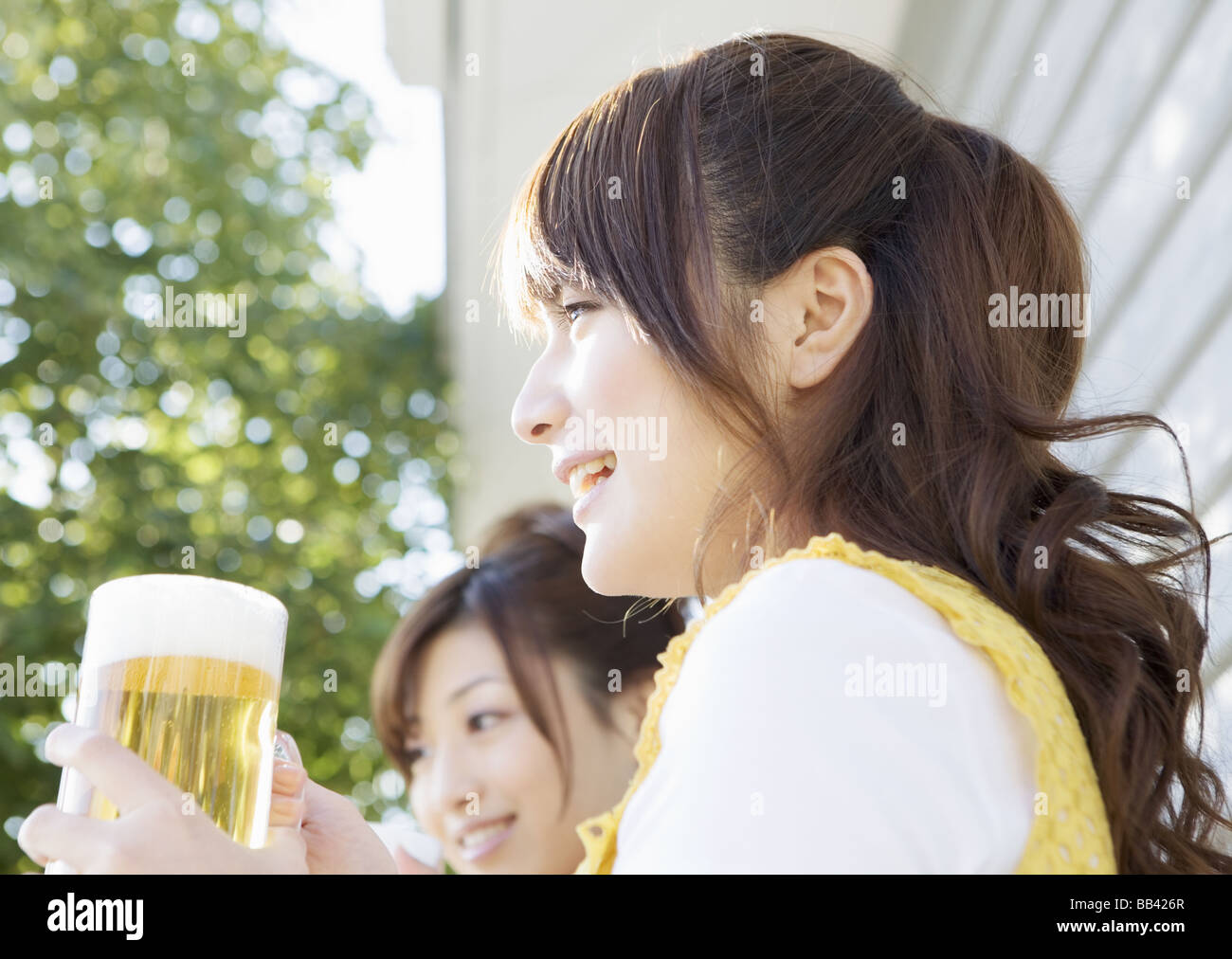 Woman holding beer mug Stock Photo - Alamy