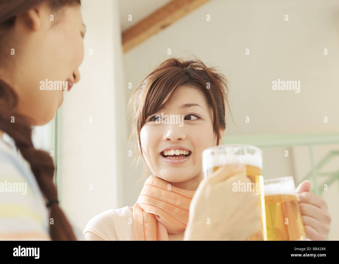Woman holding beer mug Stock Photo - Alamy