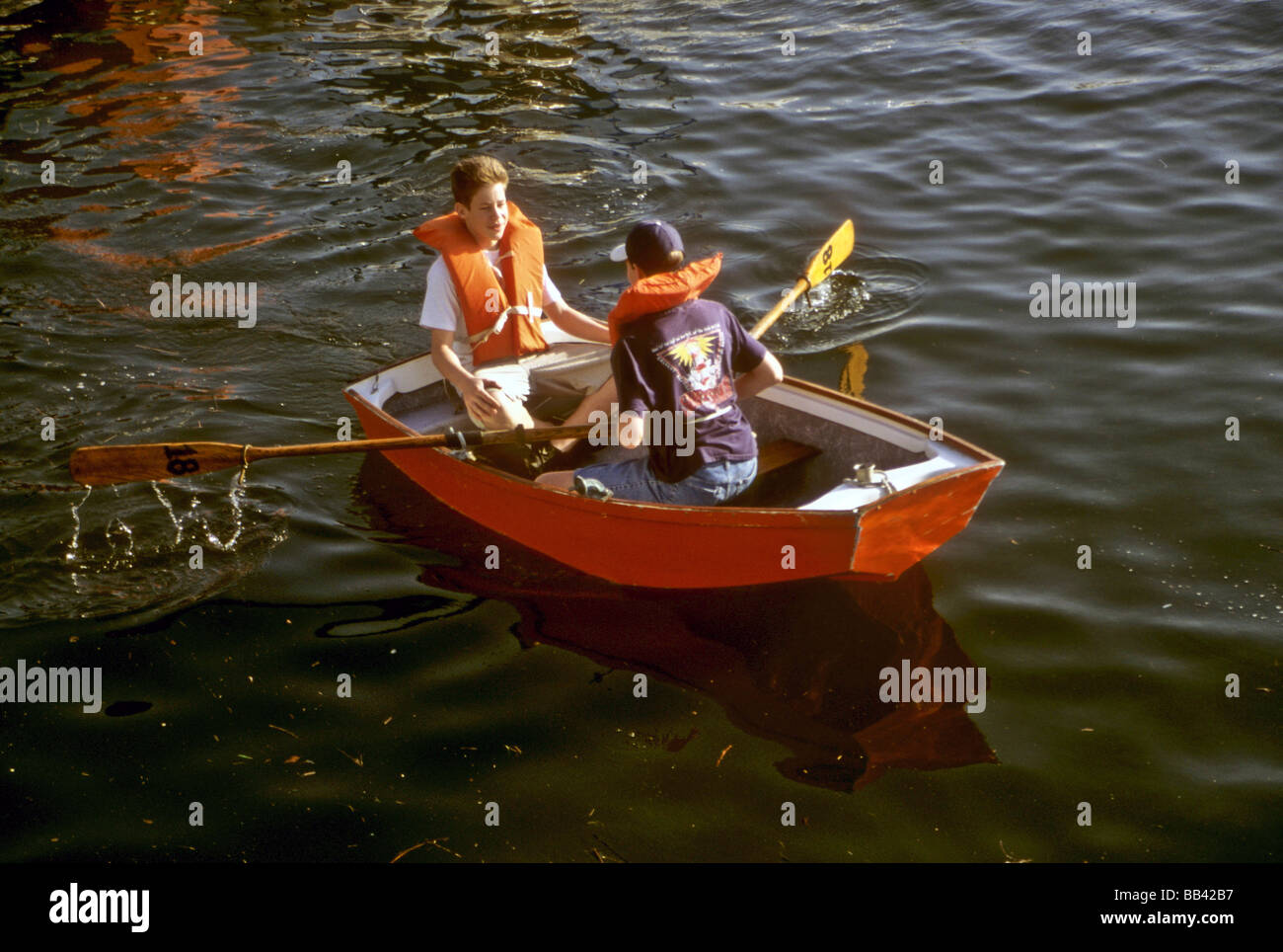 Boy boat row safe vest float oar paddle water sea ocean bay lake sport ...