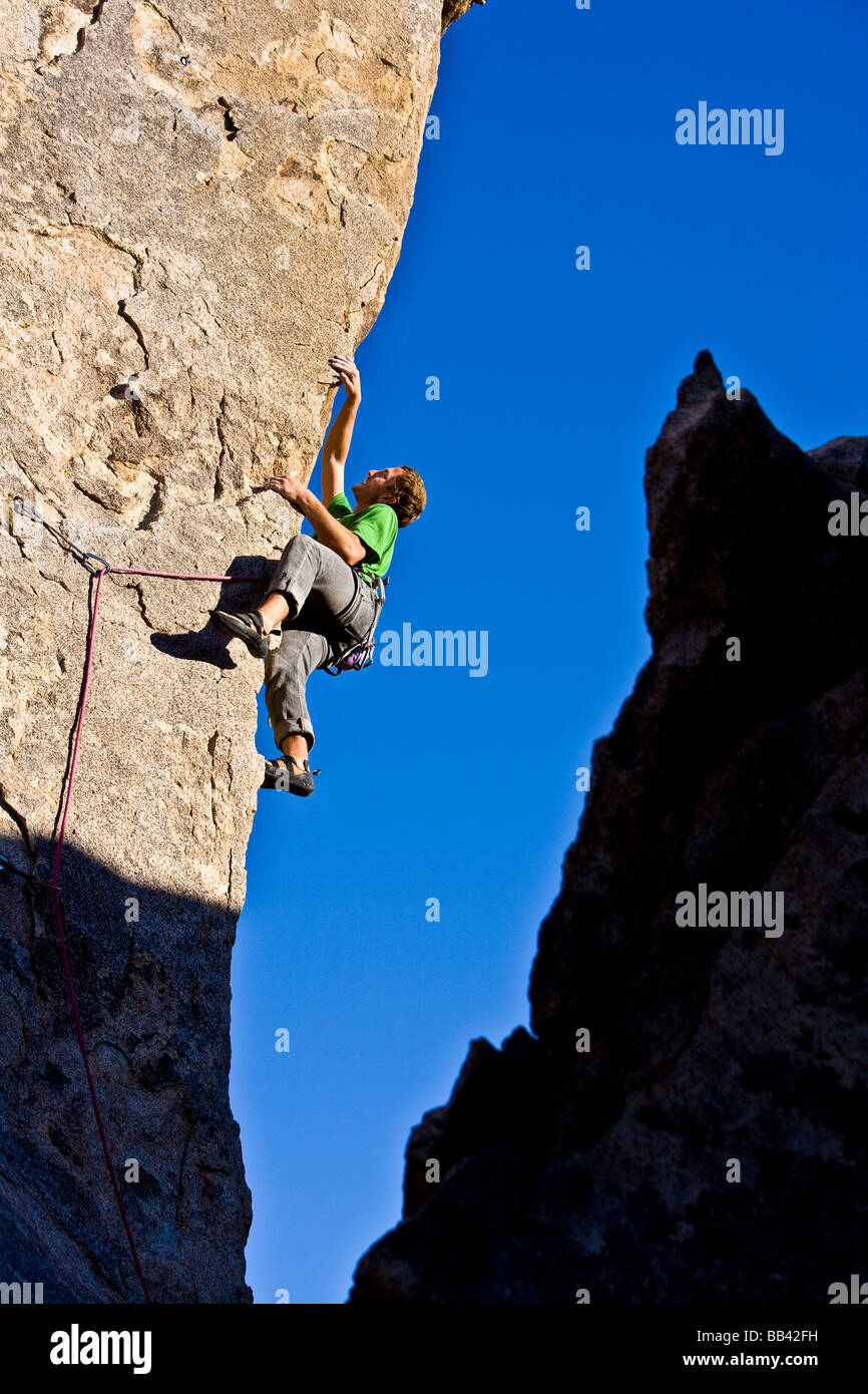 Climber ascending a steep rock face Stock Photo - Alamy