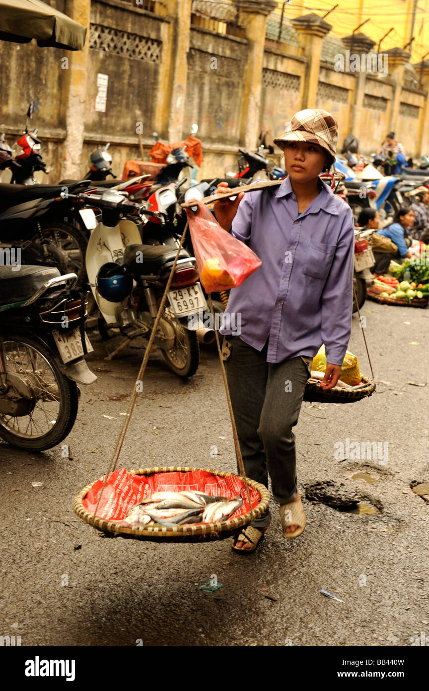 Street hawker carrying fresh fish for sale, old Quarter, Hanoi, Vitenam ...