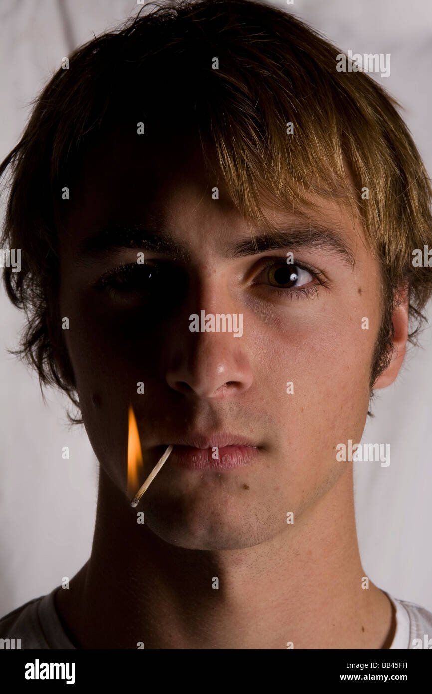 Adolescent boy poses for studio portrait with lit match, Maine Stock ...
