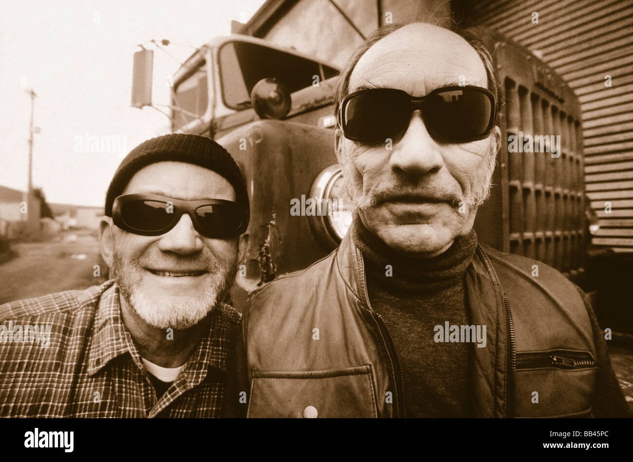 Two tough-guys standing in front of an old truck in the Georgetown ...