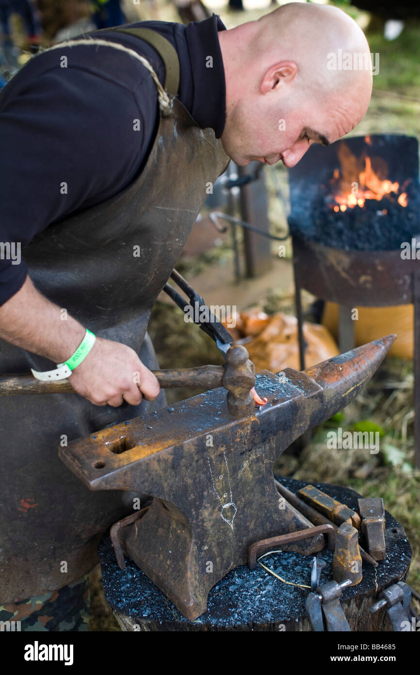 A blacksmith hammering on an anvil, The Cotswold Show 2008, Cirencester ...