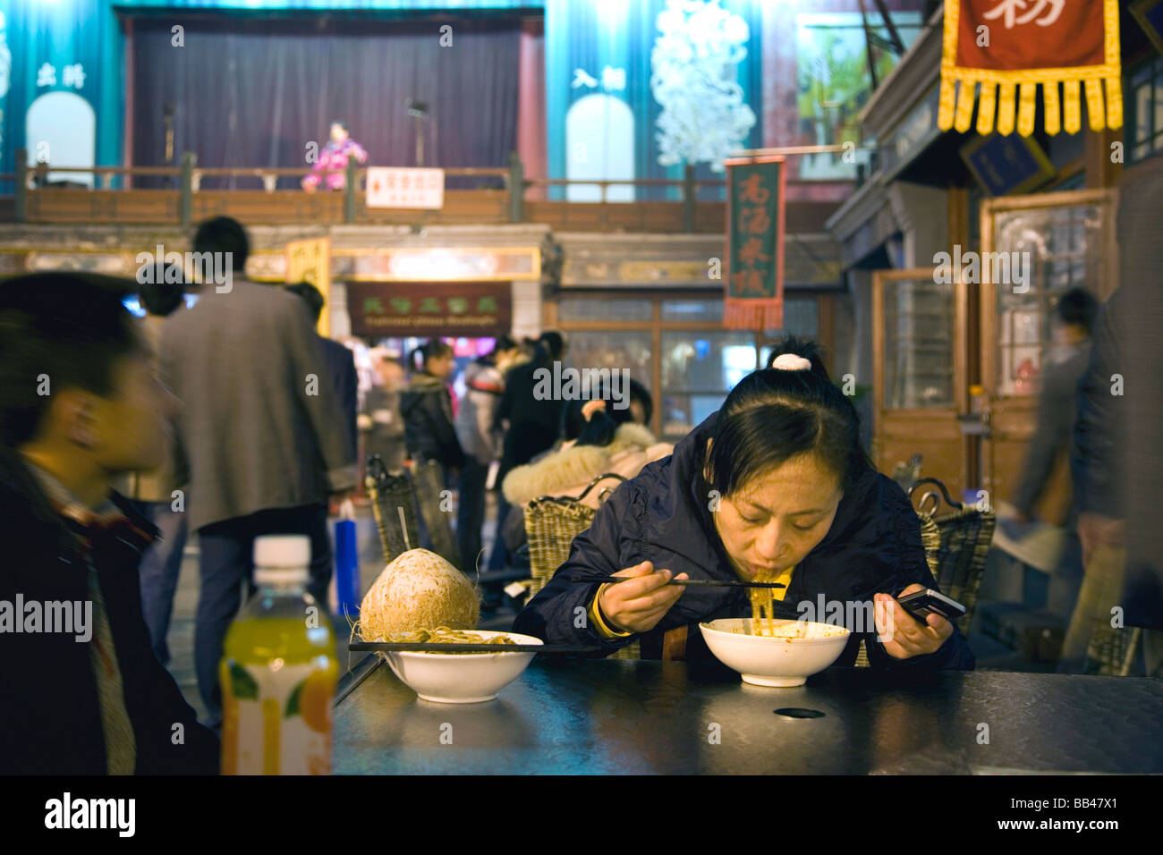 A woman eating noodles in Beijing, China Stock Photo - Alamy