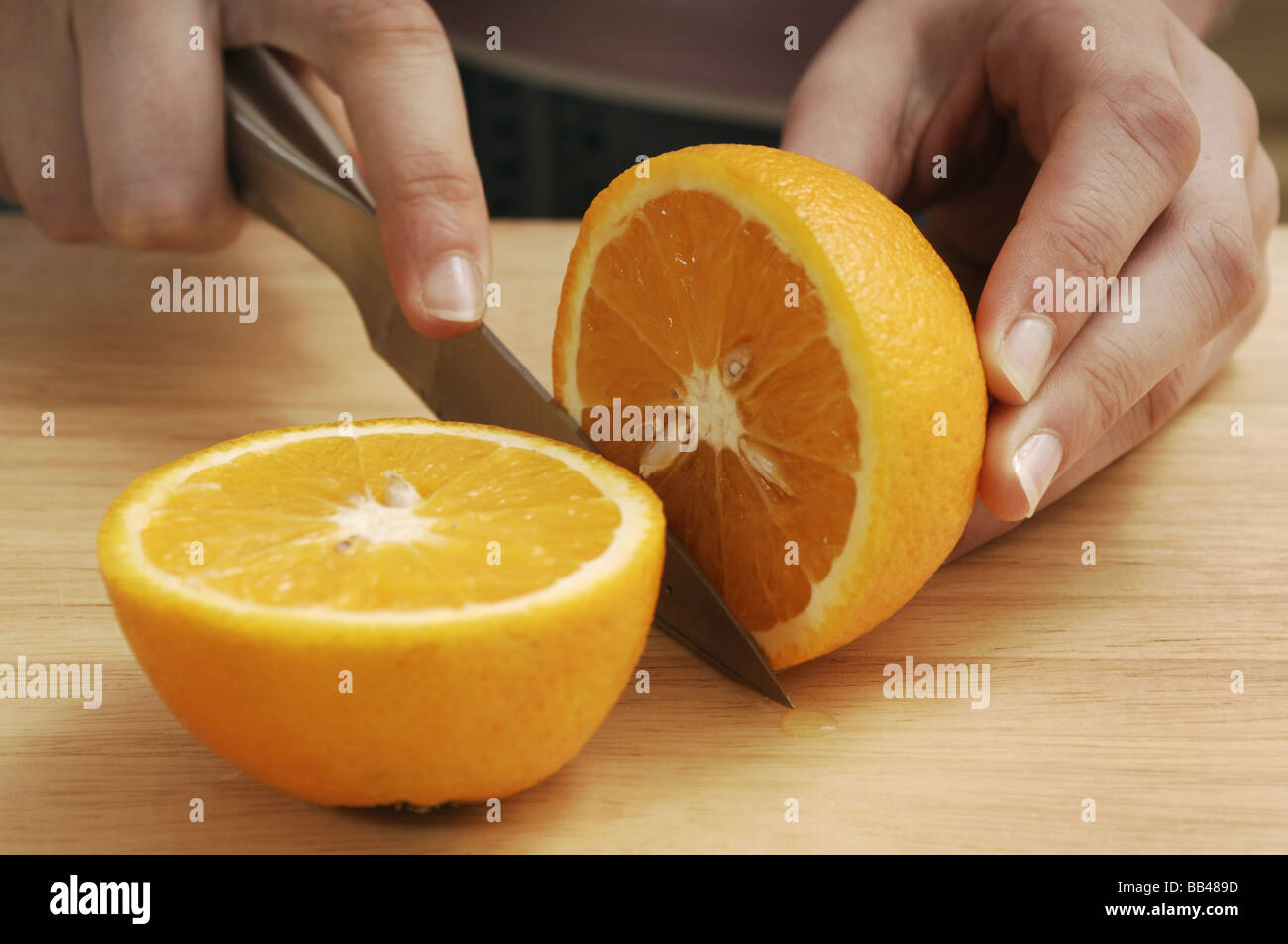 Womans hands cutting fresh orange hi-res stock photography and images ...
