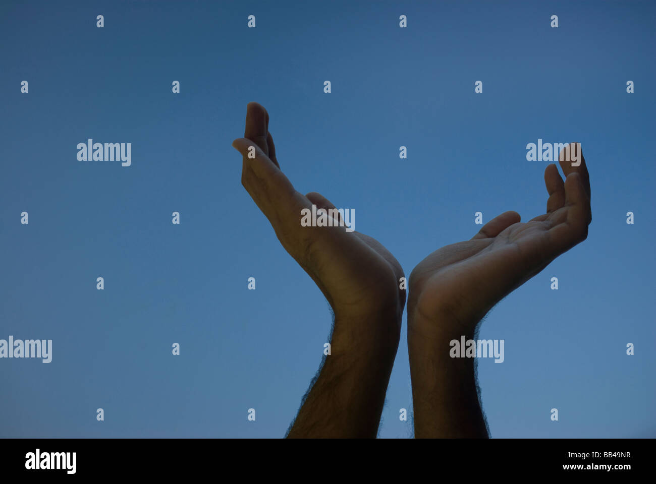 Two open hands reach out into the sky Stock Photo - Alamy