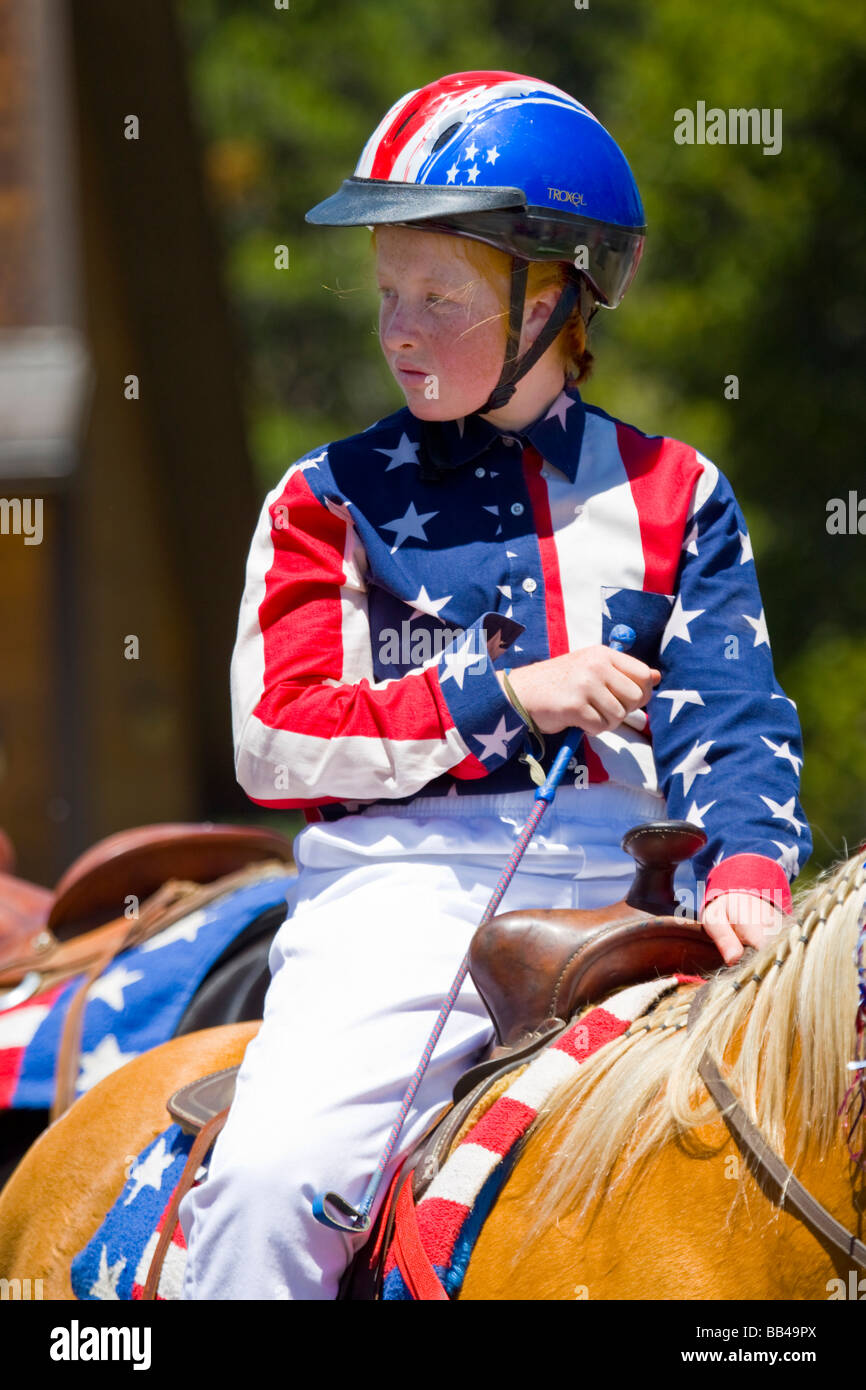 USA, Colorado, Frisco. Girl in flag colors rides horse in July 4th ...