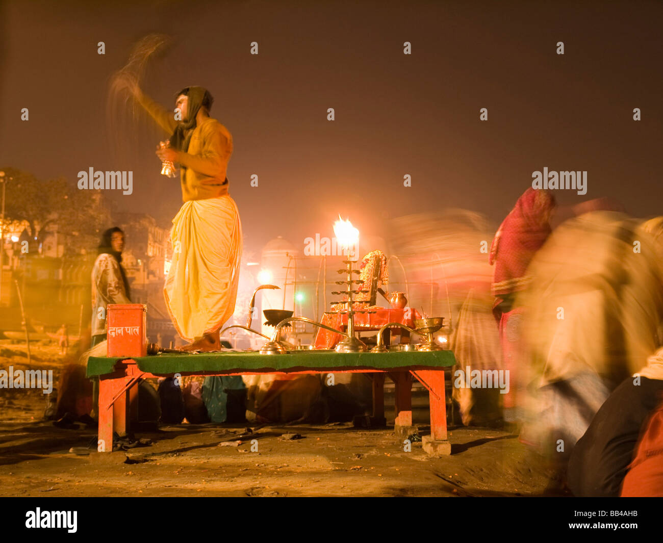 A Hindu priest performs a ritual before dawn on the bank of the holy ...