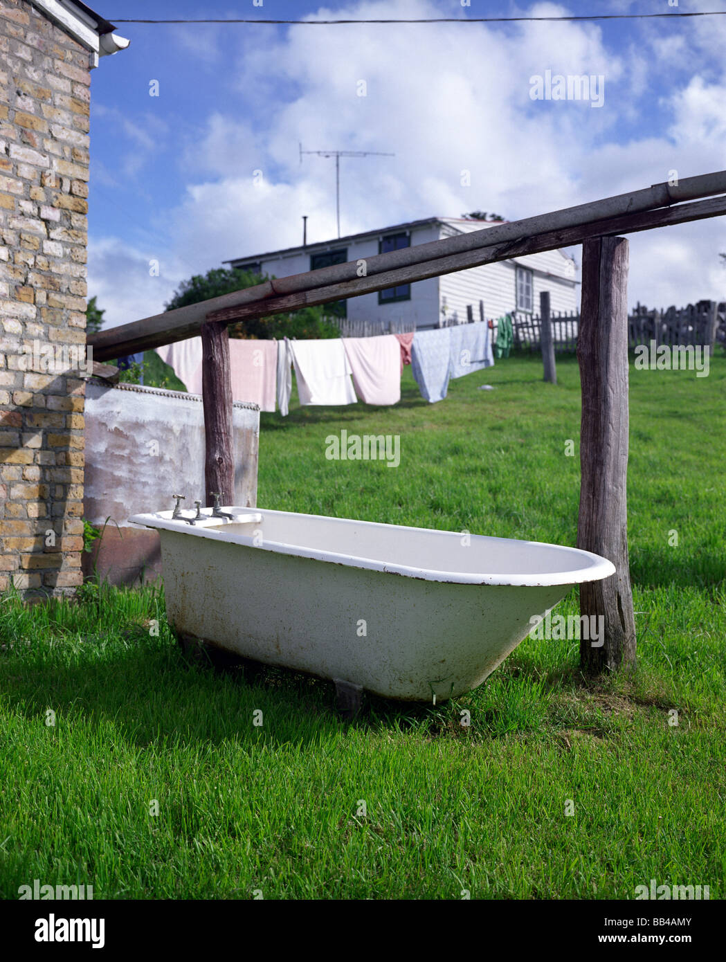 A bath tub stands outdoors near laundry Stock Photo - Alamy