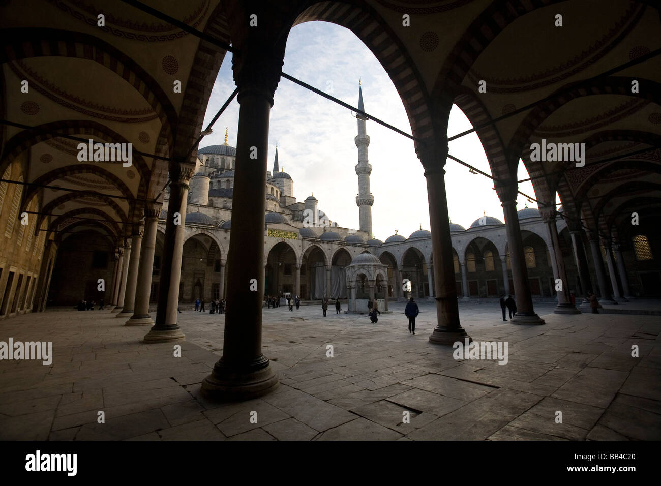 Arches frame the skyline and tower of large Mosque Stock Photo - Alamy