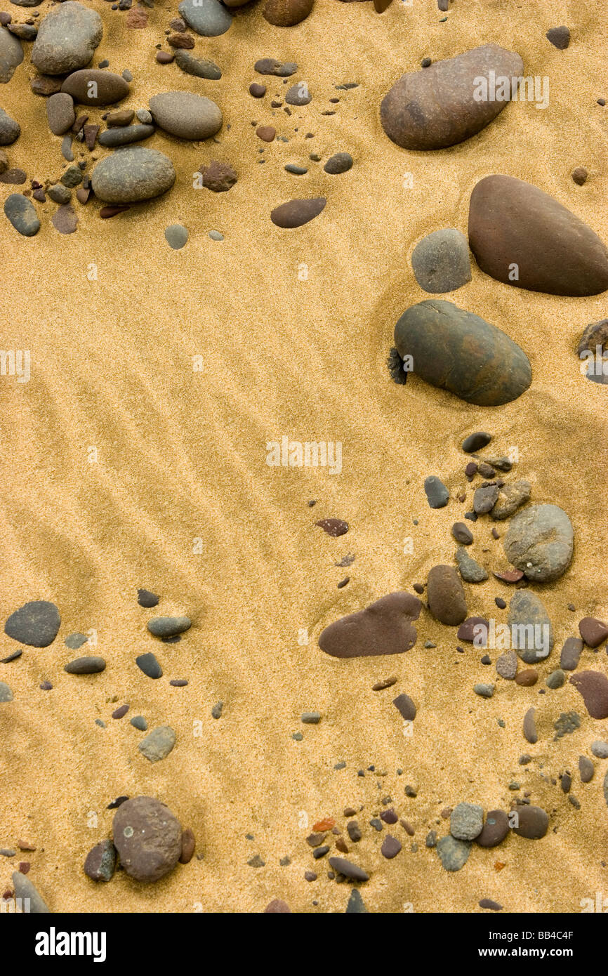 Rock imbedded in the sand along the Skeleton Coast, Namibia Stock Photo ...