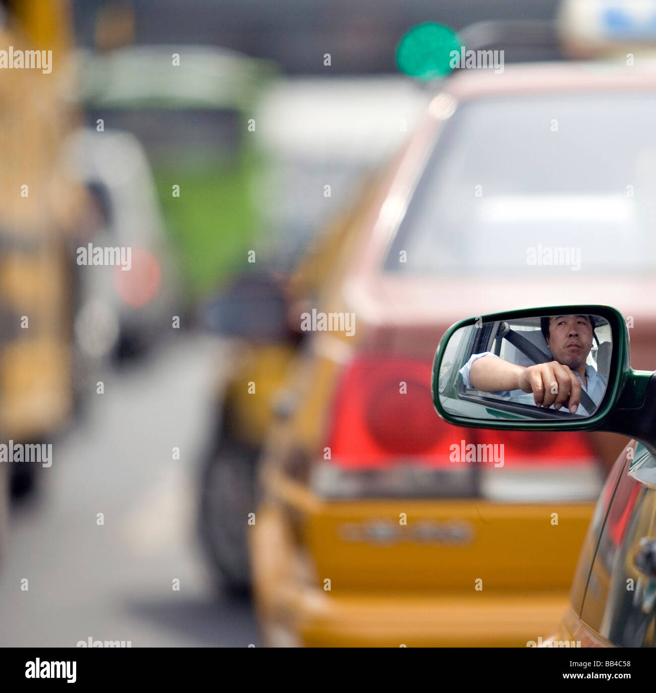 Taxi driver in rear view mirror Stock Photo - Alamy