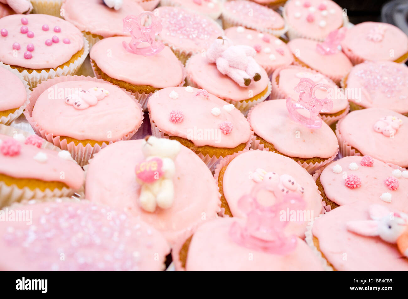 Sponge fairy cakes with pink icing on a table at a childs party Stock ...