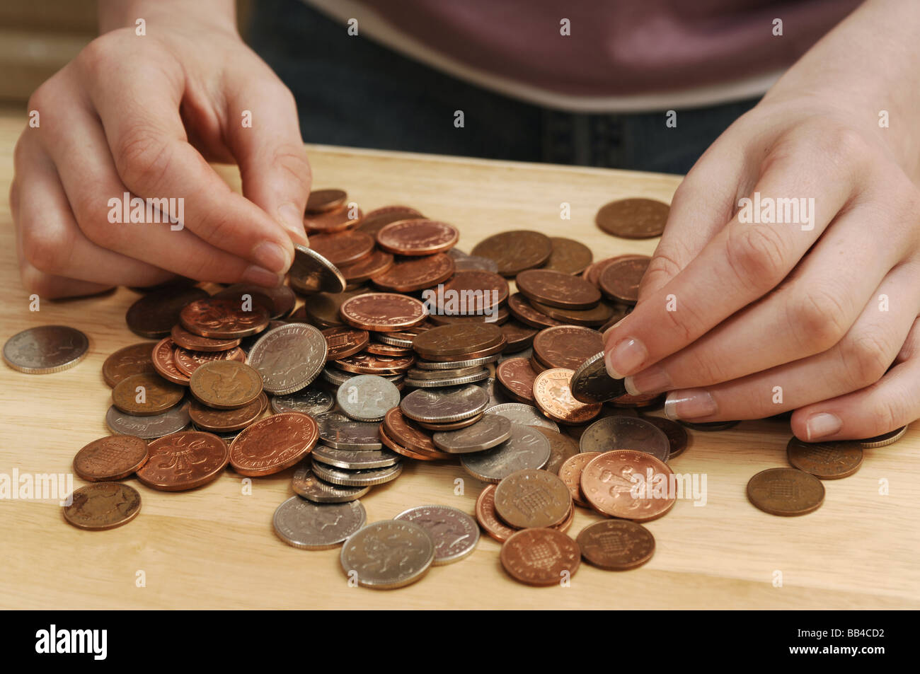 A closeup of a woman's hands counting loose change to pay the energy ...