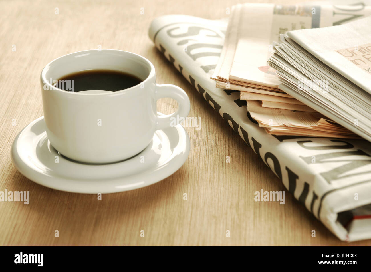 An espresso coffee and newspaper in a cafe Stock Photo - Alamy