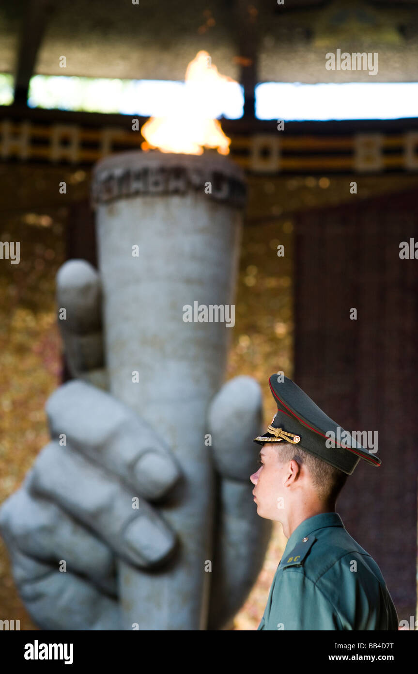 guard and a big torch (statue) at the back Stock Photo - Alamy