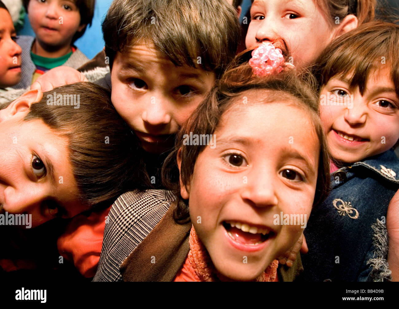Children crowd around the camera at a Kabul child care center Stock ...