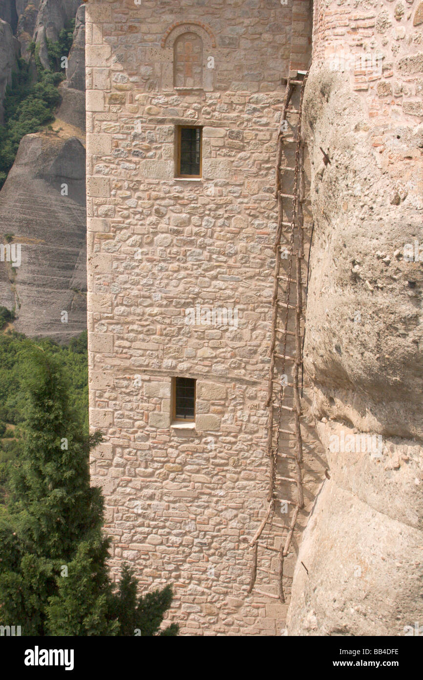 Europe, Greece, Meteora. Escape ladder and chain against stone wall at ...