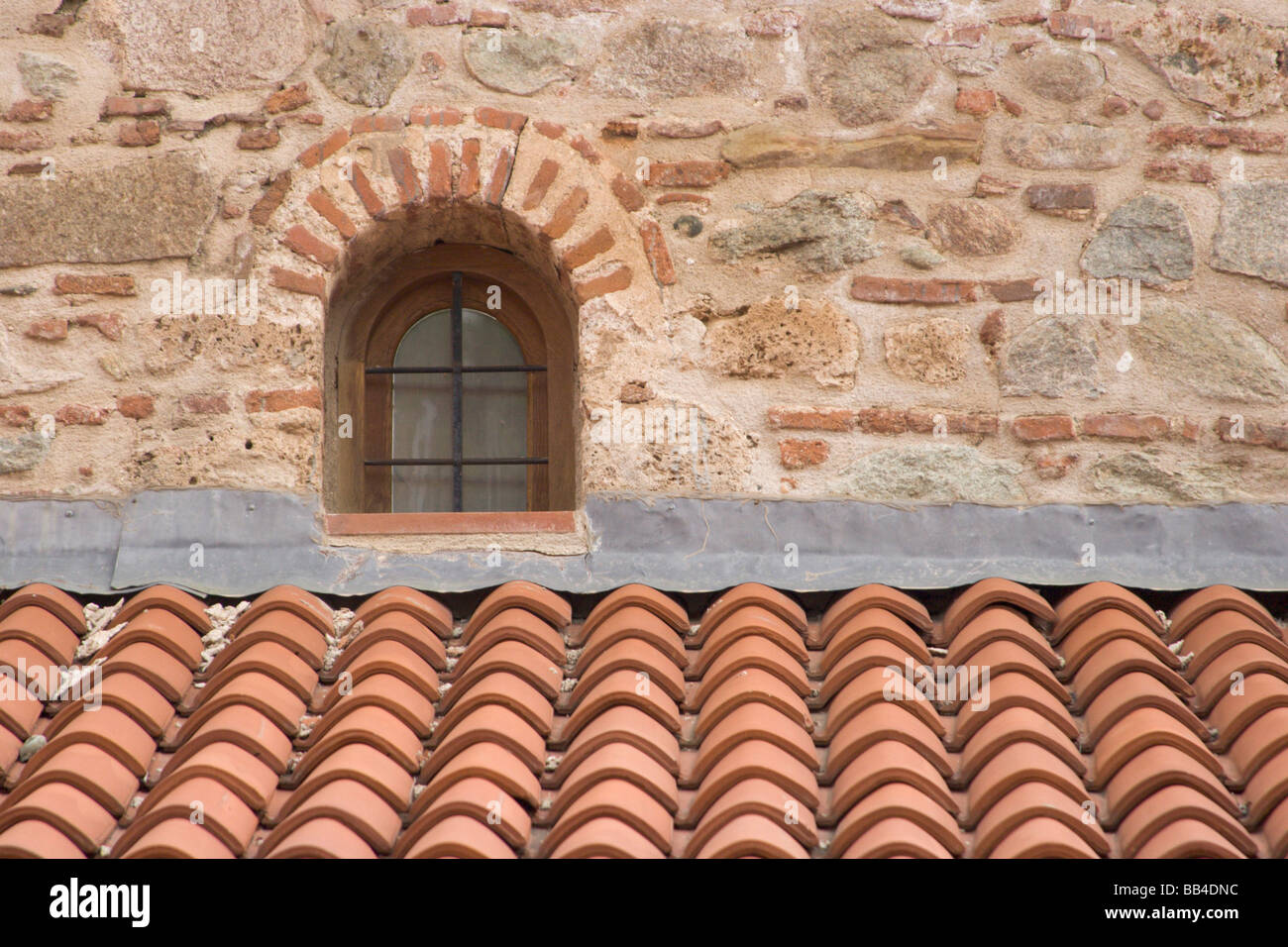 Europe, Greece, Meteora. Tile roof and small window in Grand Meteora ...