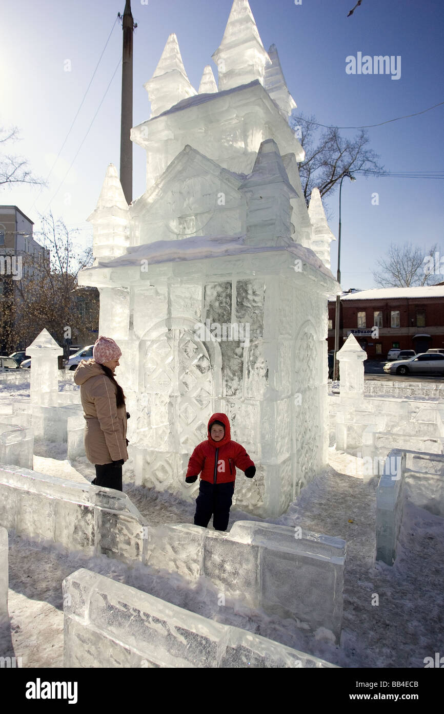 A woman and child playing in an ice playground in the winter in Irkutsk ...